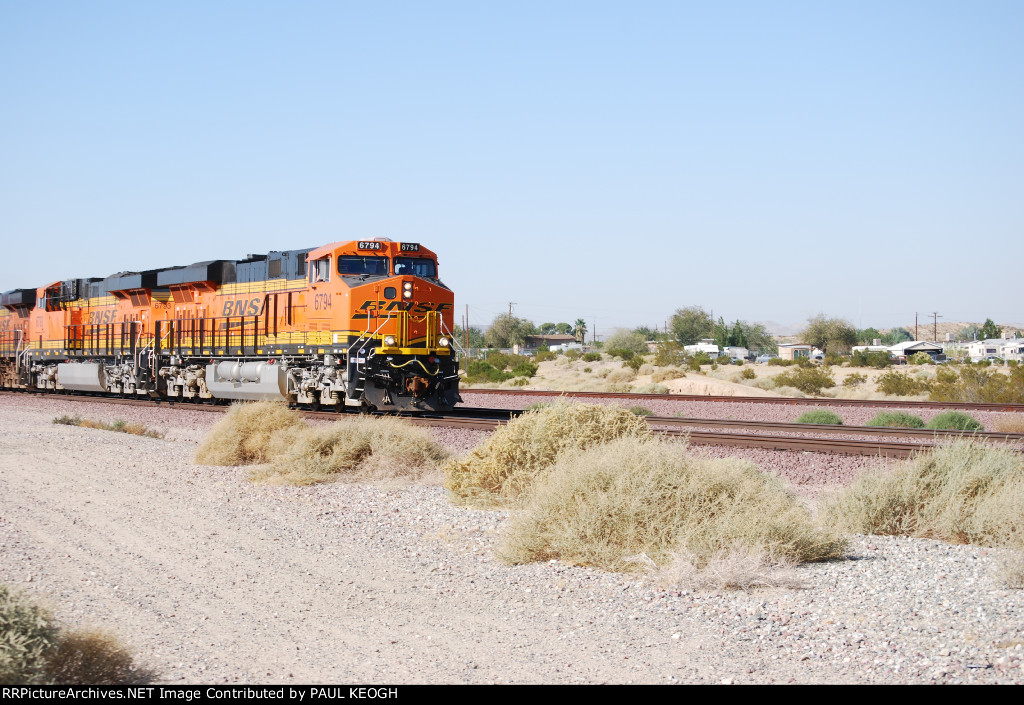 BNSF 6794 and her Sister C4 BNSF 6793 start to slow down to enter the BNSF Barstow yard for a ...